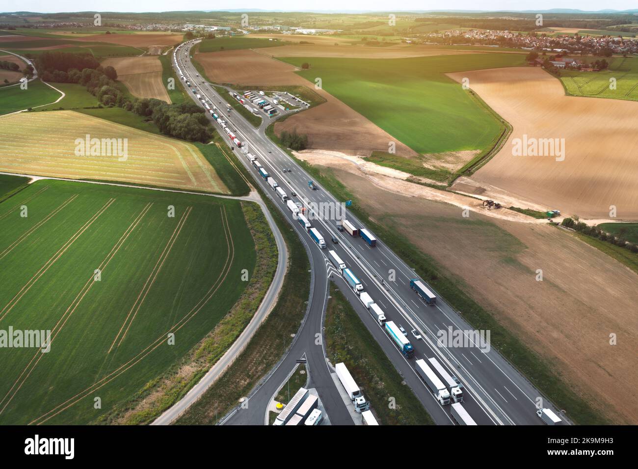 Aerial view of logistic traffic and parking lots full of trucks on ...