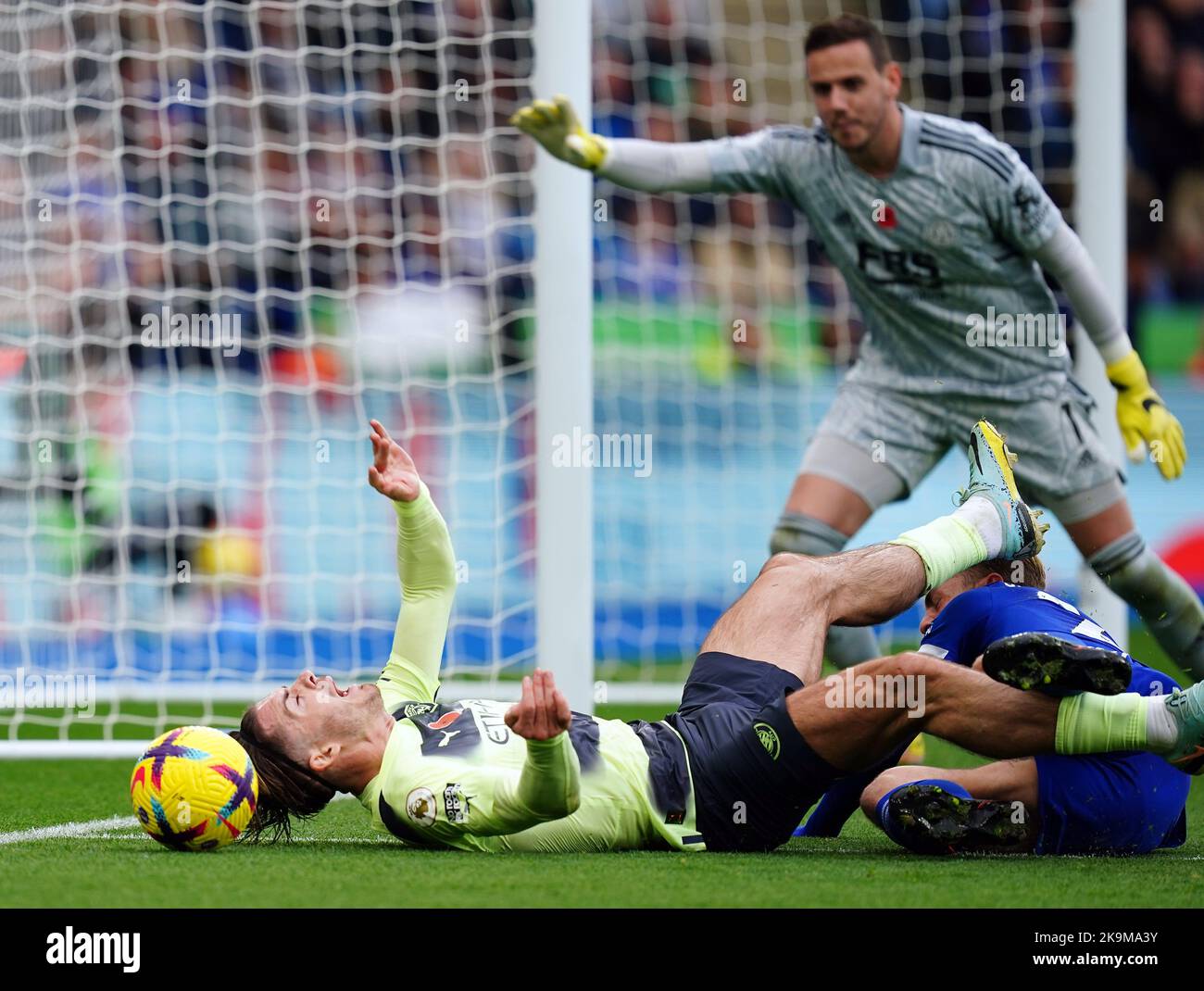 Manchester City's Jack Grealish goes down under pressure from Leicester ...