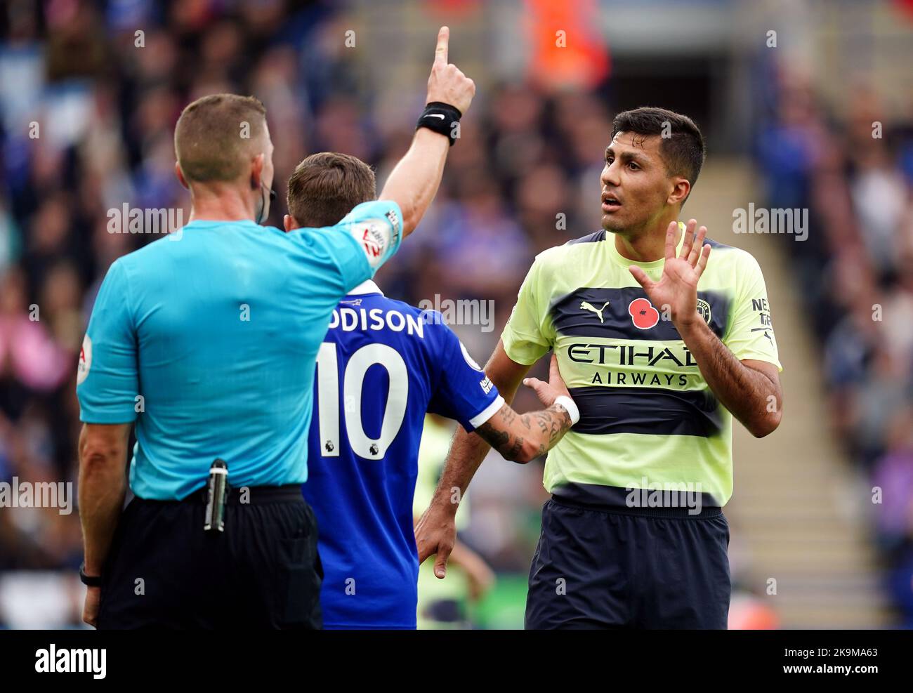 Referee Robert Jones waves away Manchester City's Rodri during the ...