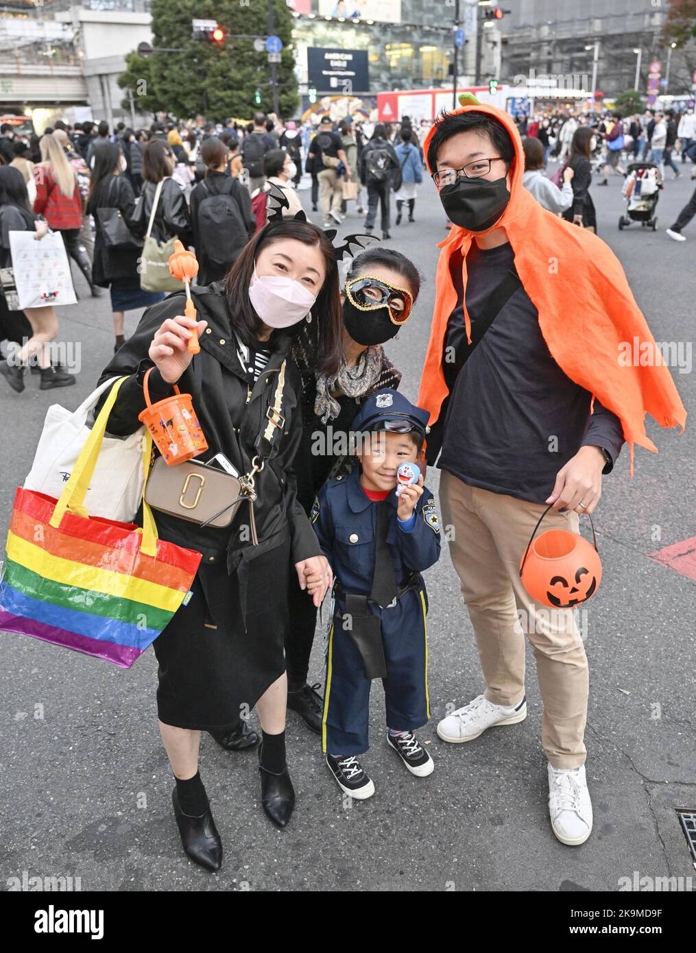People pose in costume at a scramble intersection in Tokyo's Shibuya ...