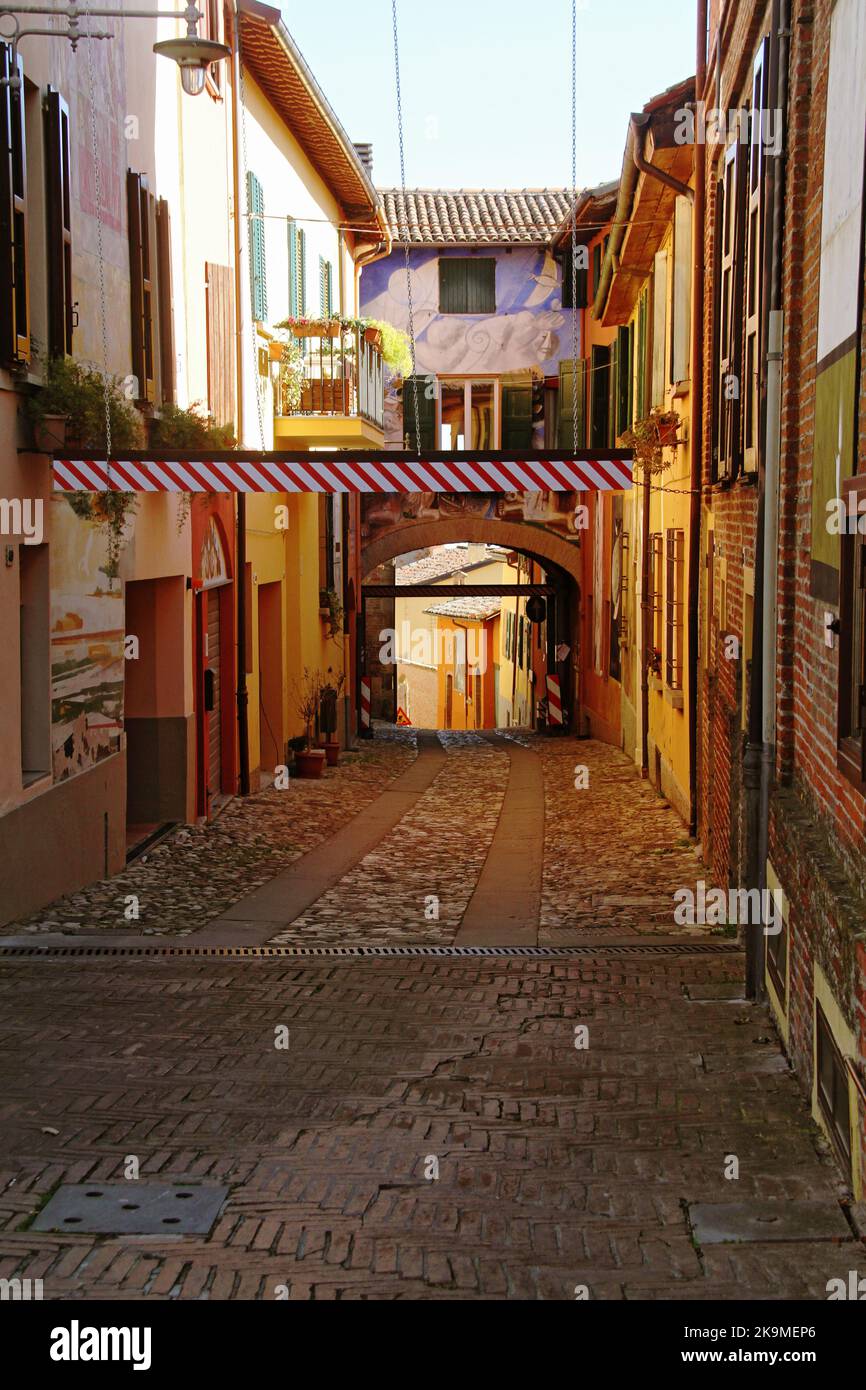 Dozza, Italy. Narrow alleyway with low clearance warning before ...