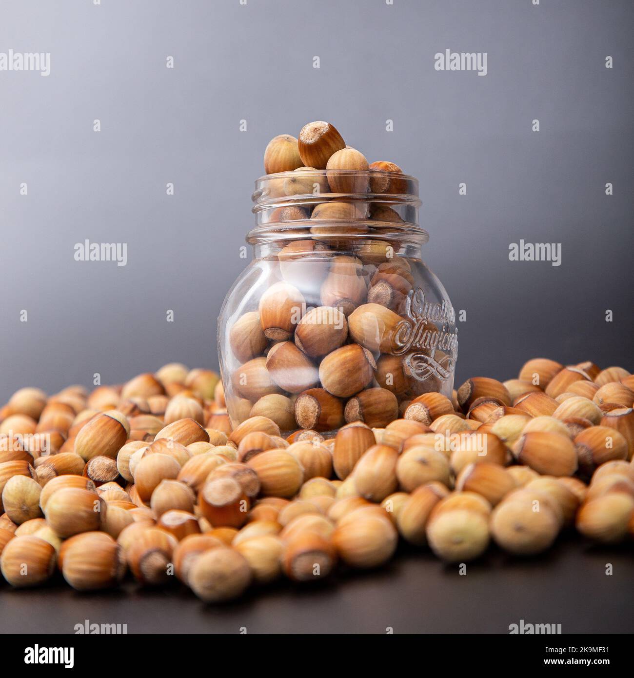 Hazelnut in a jar. Lots of hazelnuts. Bank with nuts on a black ...