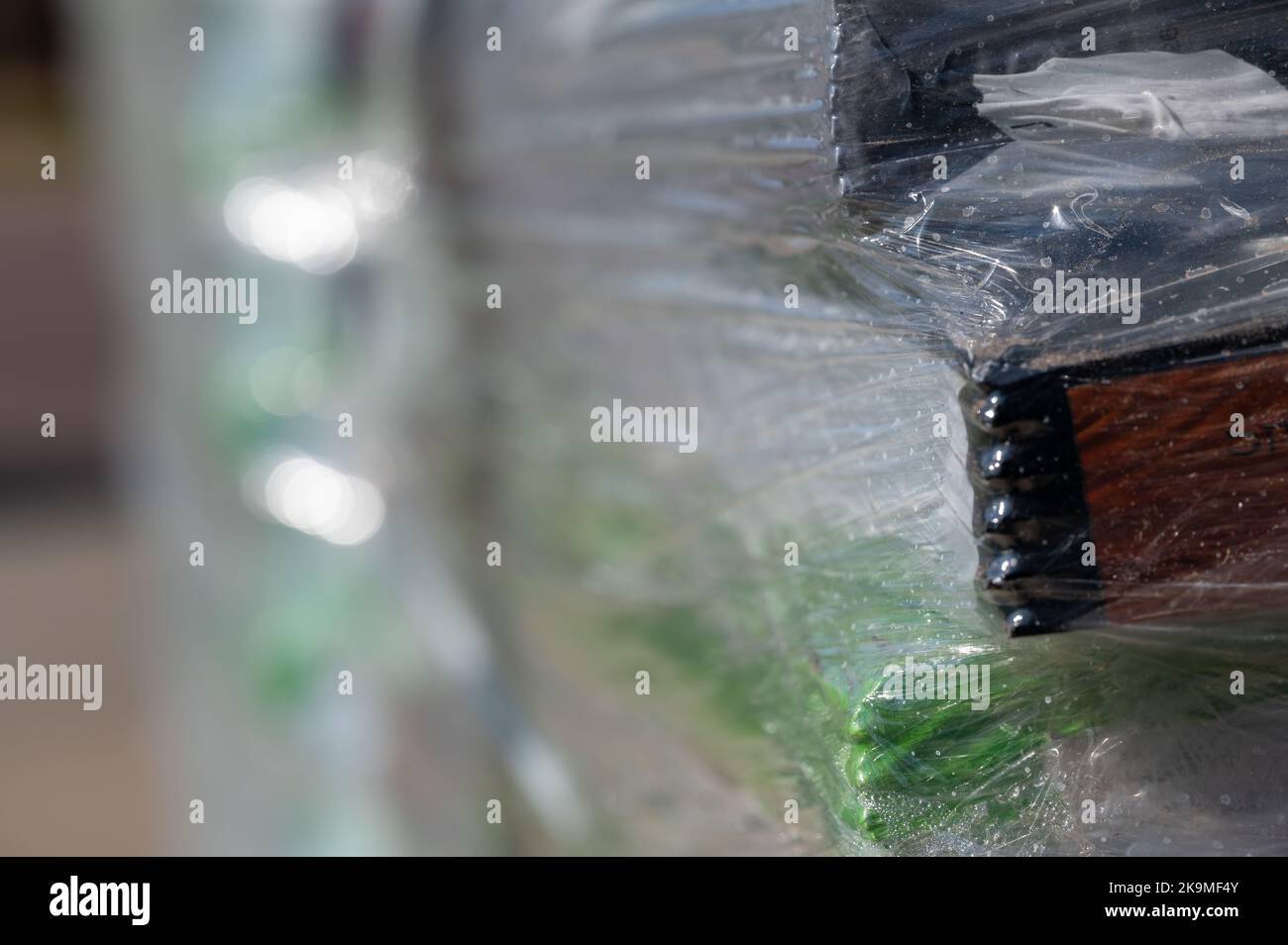 Selective focus on cellophane shrink wrap on pallets of goods for ...