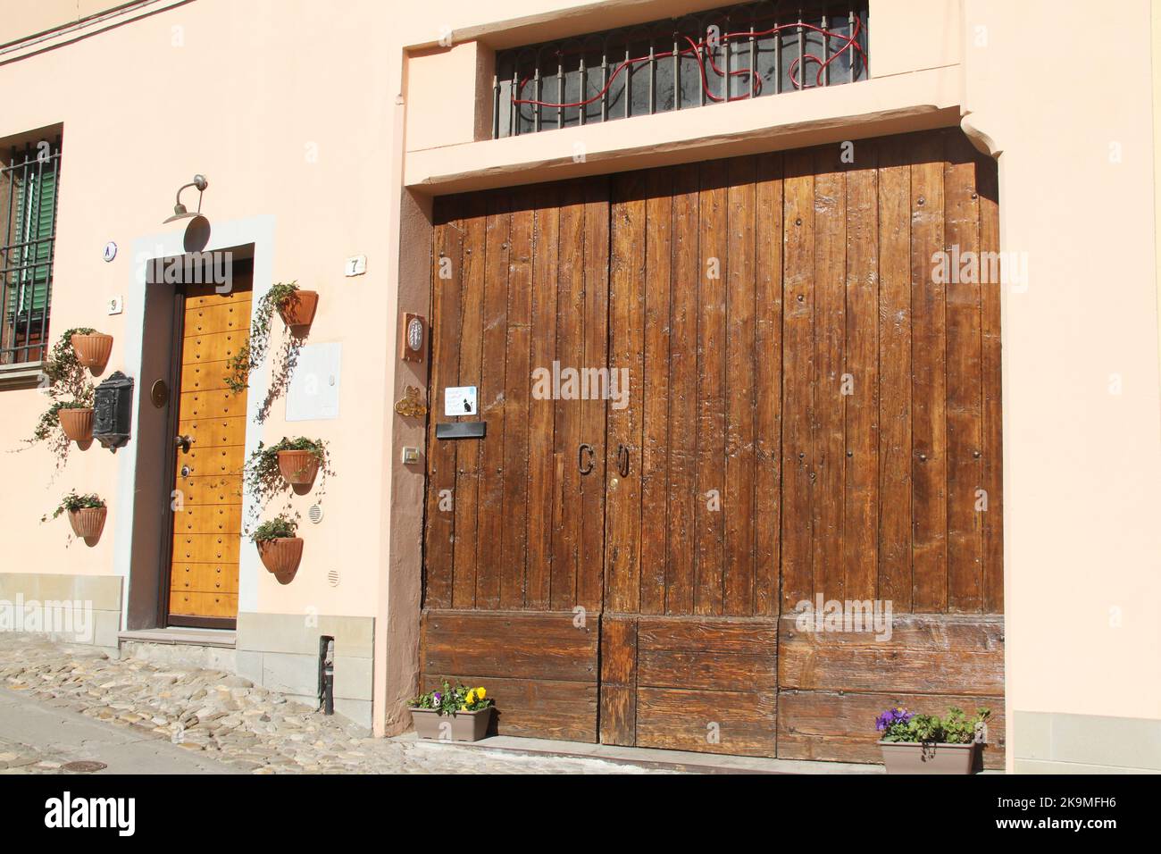 Facade of old building with gate and door in the medieval town of Dozza ...
