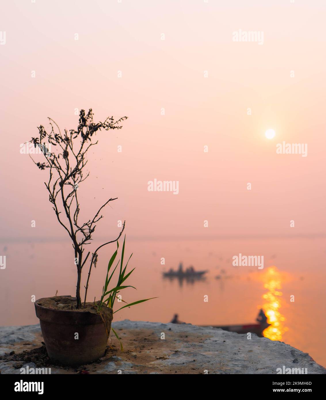 flower pot in sunrise sunset in front of reiver ganges in varanasi ...