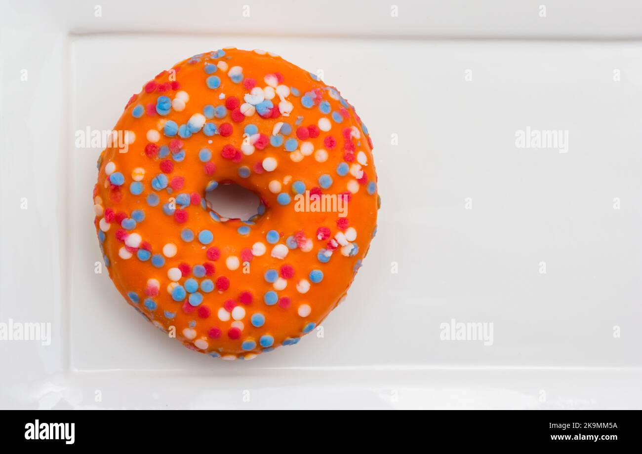 Orange donut with sprinkles in the colors of the dutch flag for ...