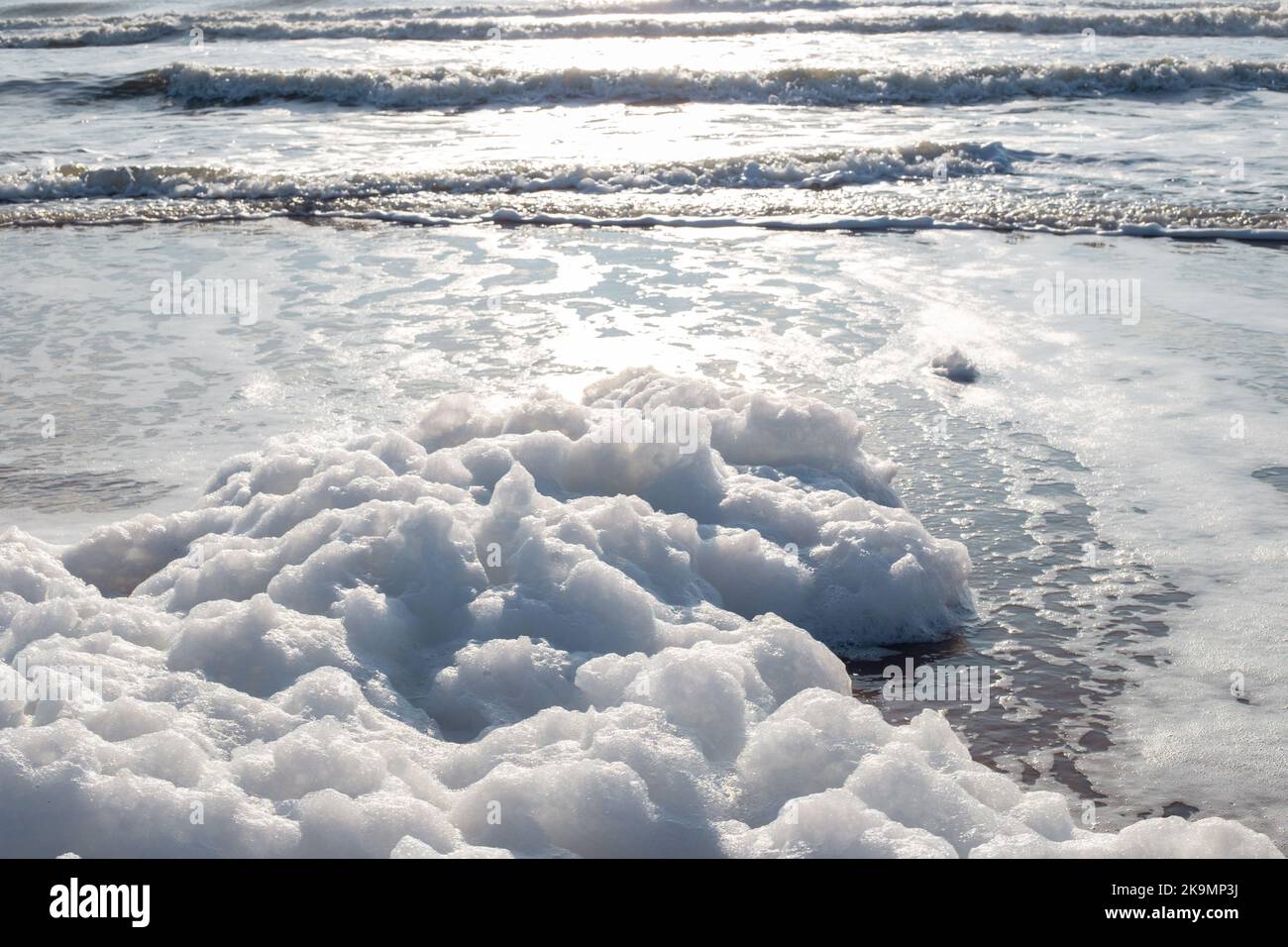 Sea wave with thick coastal foam on the shore Stock Photo - Alamy