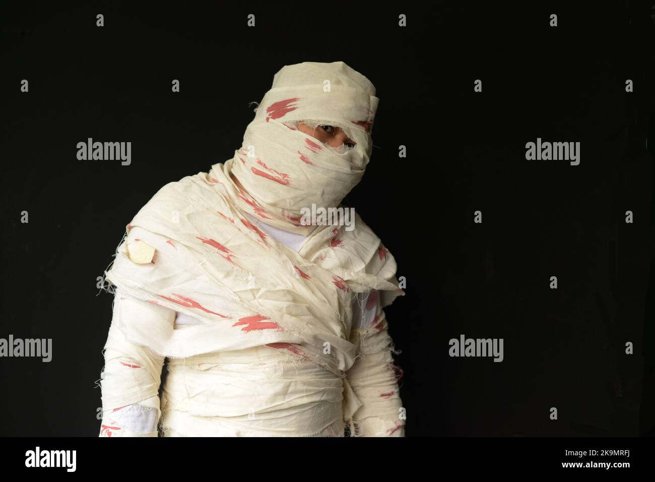 Bandaged mummy in standing position with black background on Halloween ...