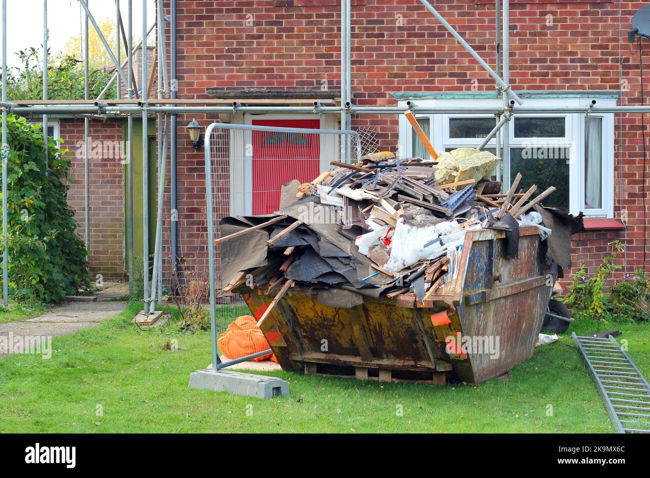 Rubbish skip outside a house being renovated. Skip full of replaced ...