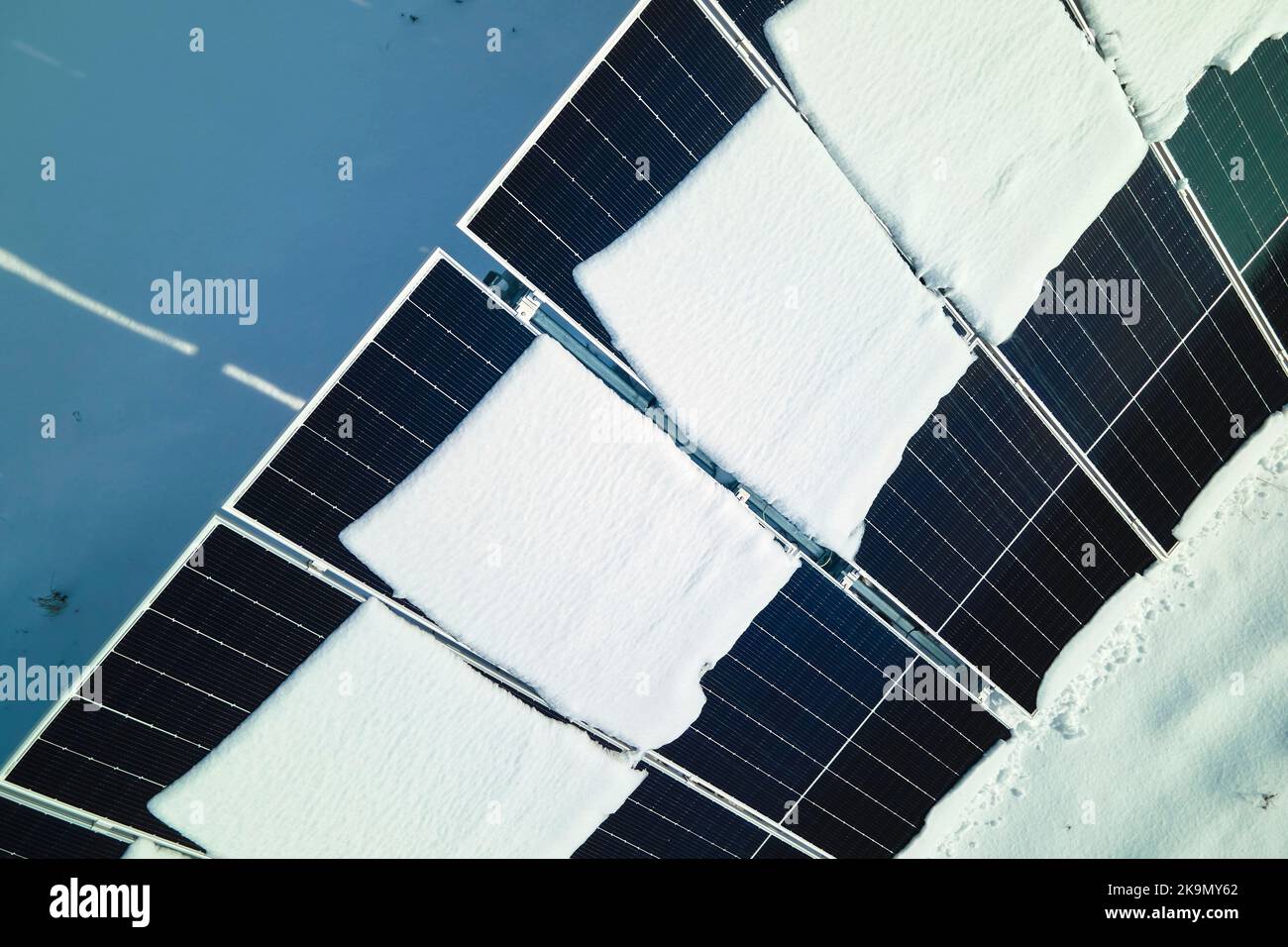 Aerial view of snow melting from covered solar photovoltaic panels at ...