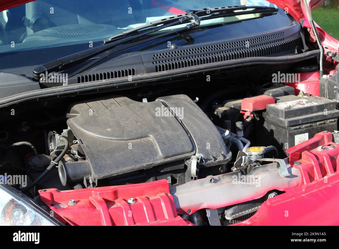 Small car with hood or bonnet open revealing engine Stock Photo - Alamy