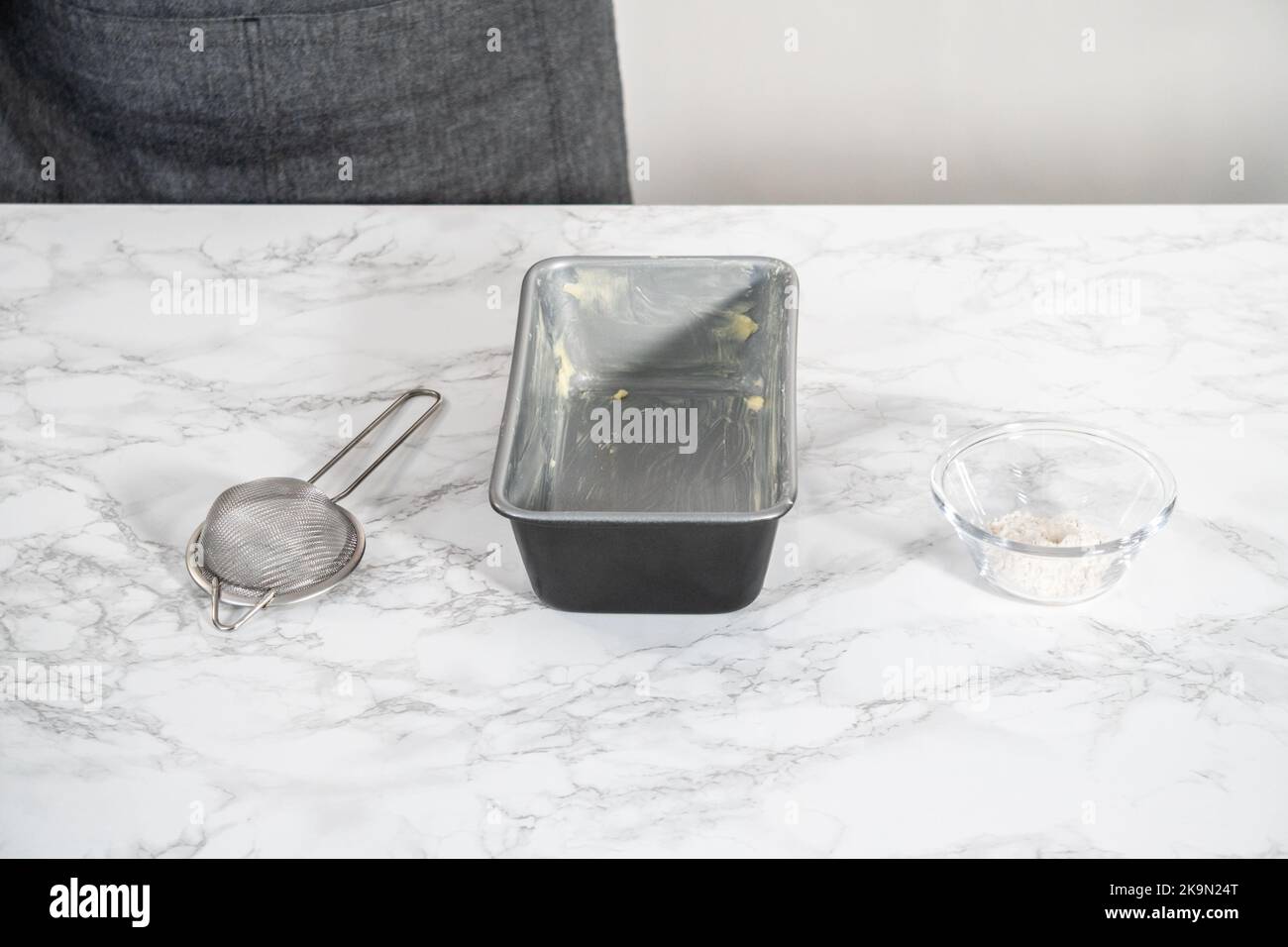 Greasing baking pan Stock Photo - Alamy