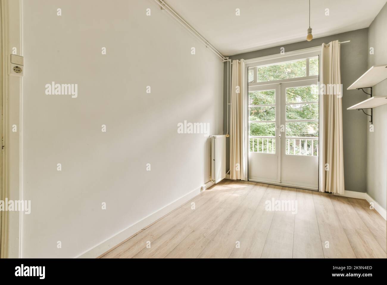 cupboard placed near doors and wicker basket in spacious room with ...