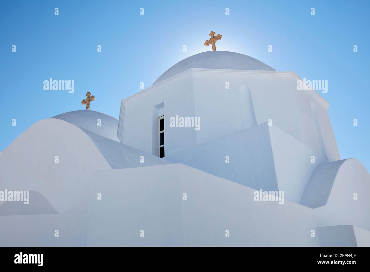 Typical white greek Chapelle with Gloriole light behind Stock Photo - Alamy