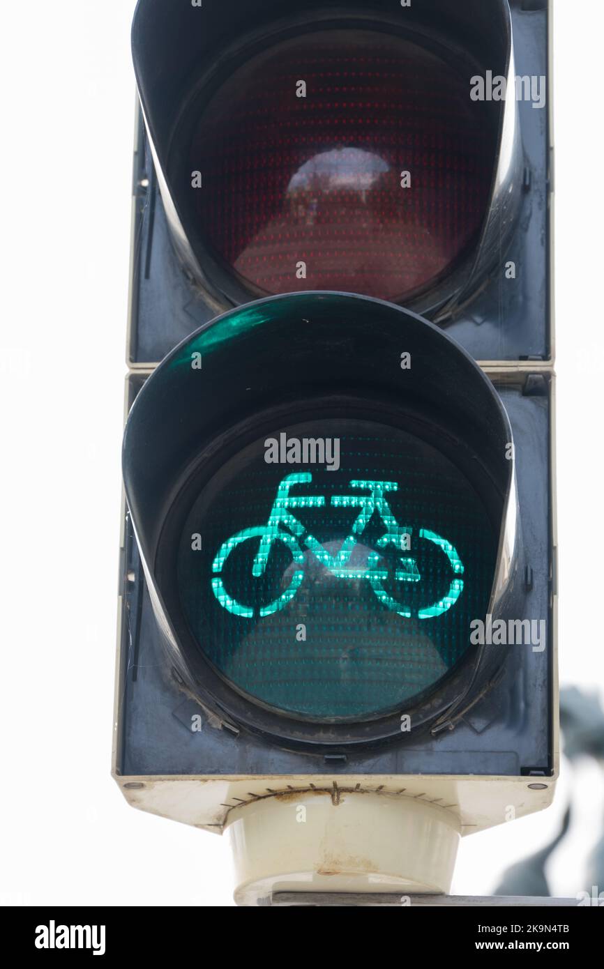 Close up of traffic light for cyclists with green light and bike as ...