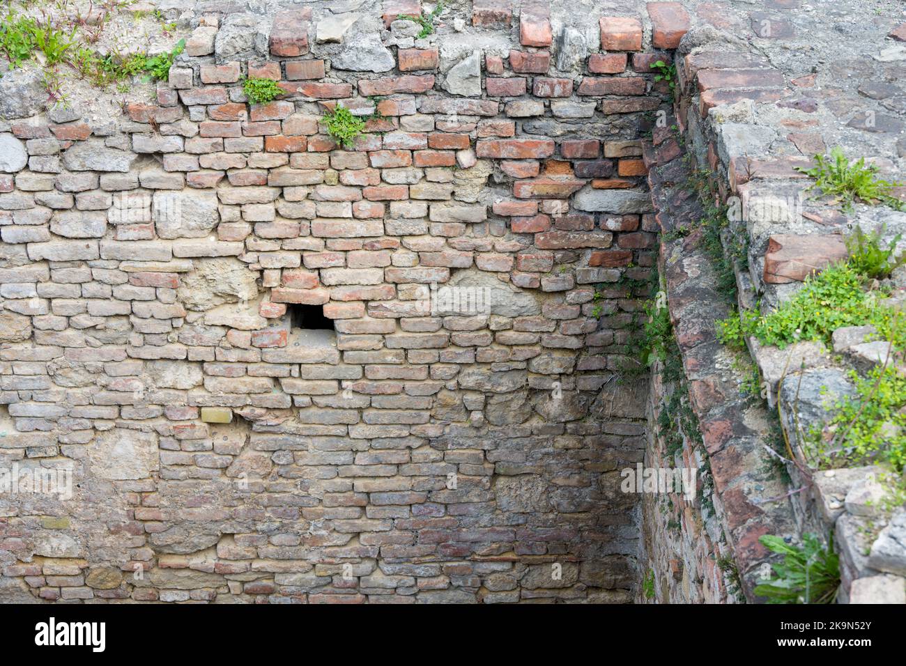 Excavation of an old ancient Roman brick wall with visible corner ...