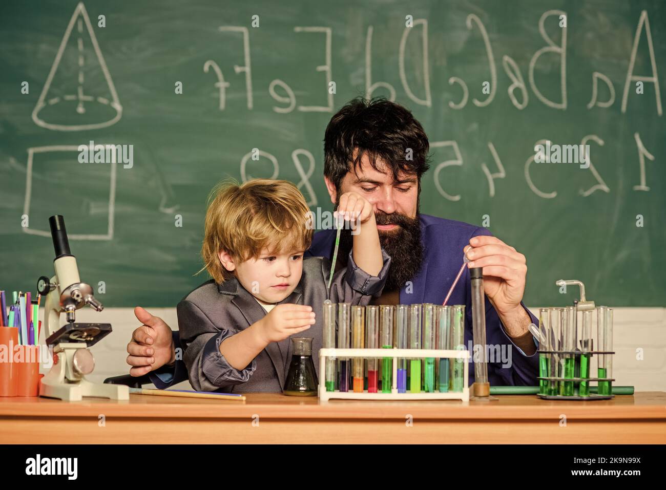 Know How. laboratory research and development. teacher man with little ...