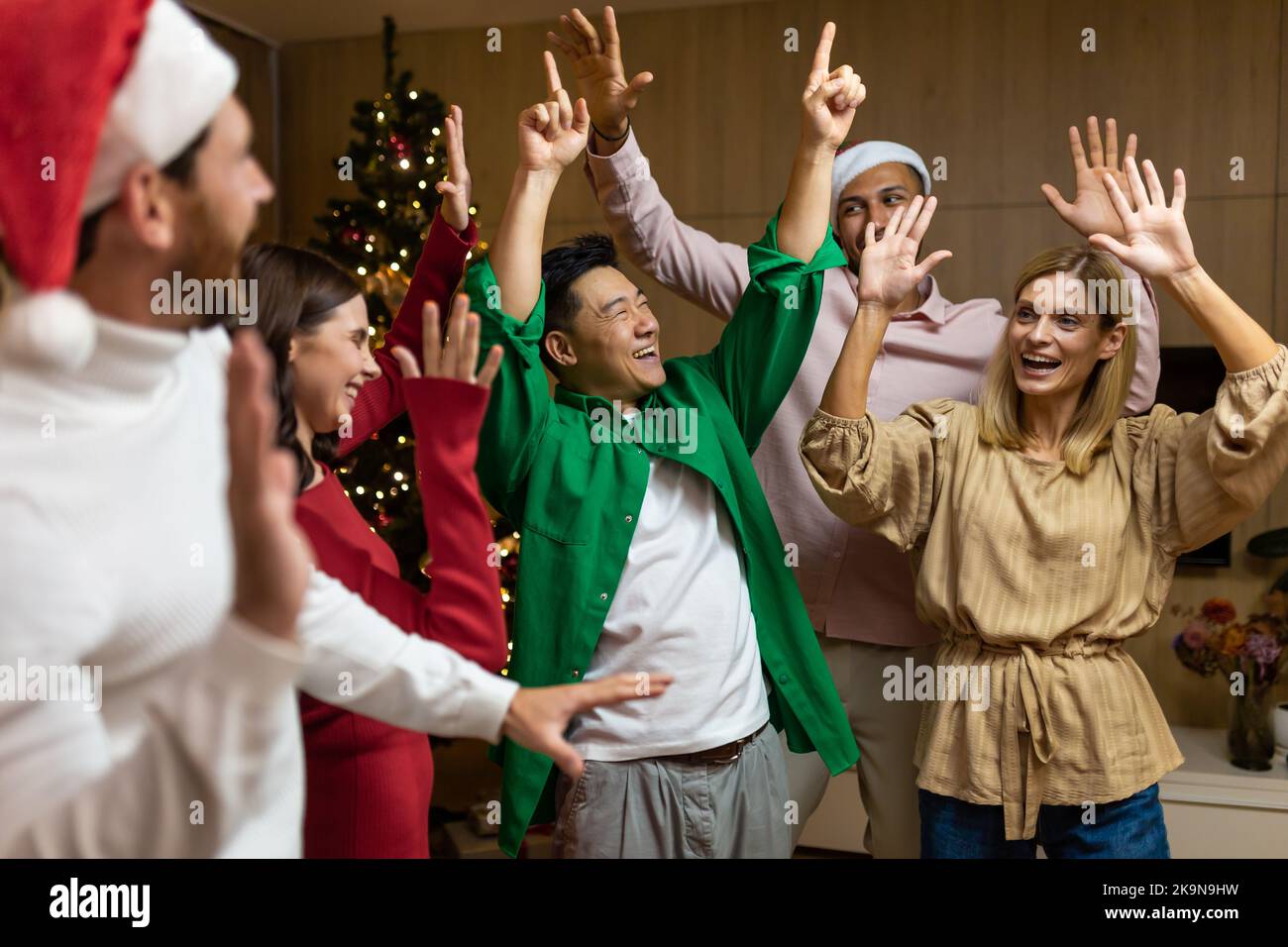 Cheerful Group friends celebrate New Year's party at home dancing ...