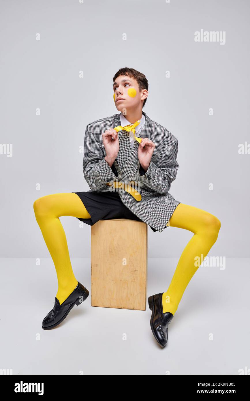 Portrait of stylish boy posing in jacket, blazer and yellow tights ...