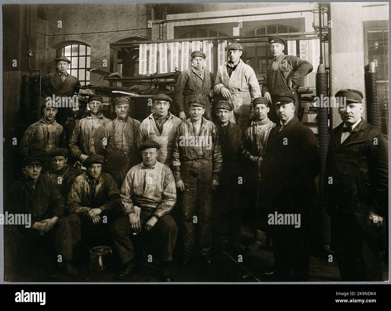 The painting team. Signs in the background - Smoking forbidden. Group ...