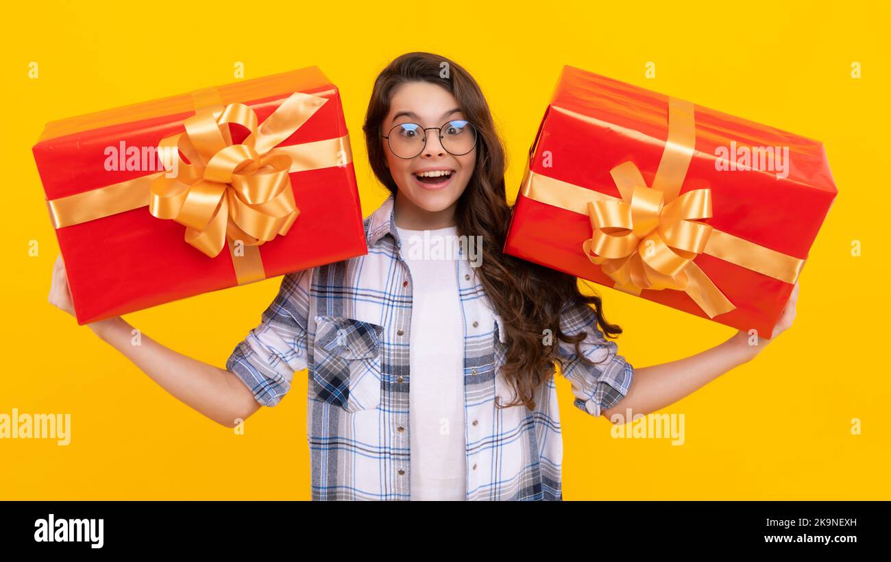 surprised teen kid in glasses with present. studio shot of teen kid ...