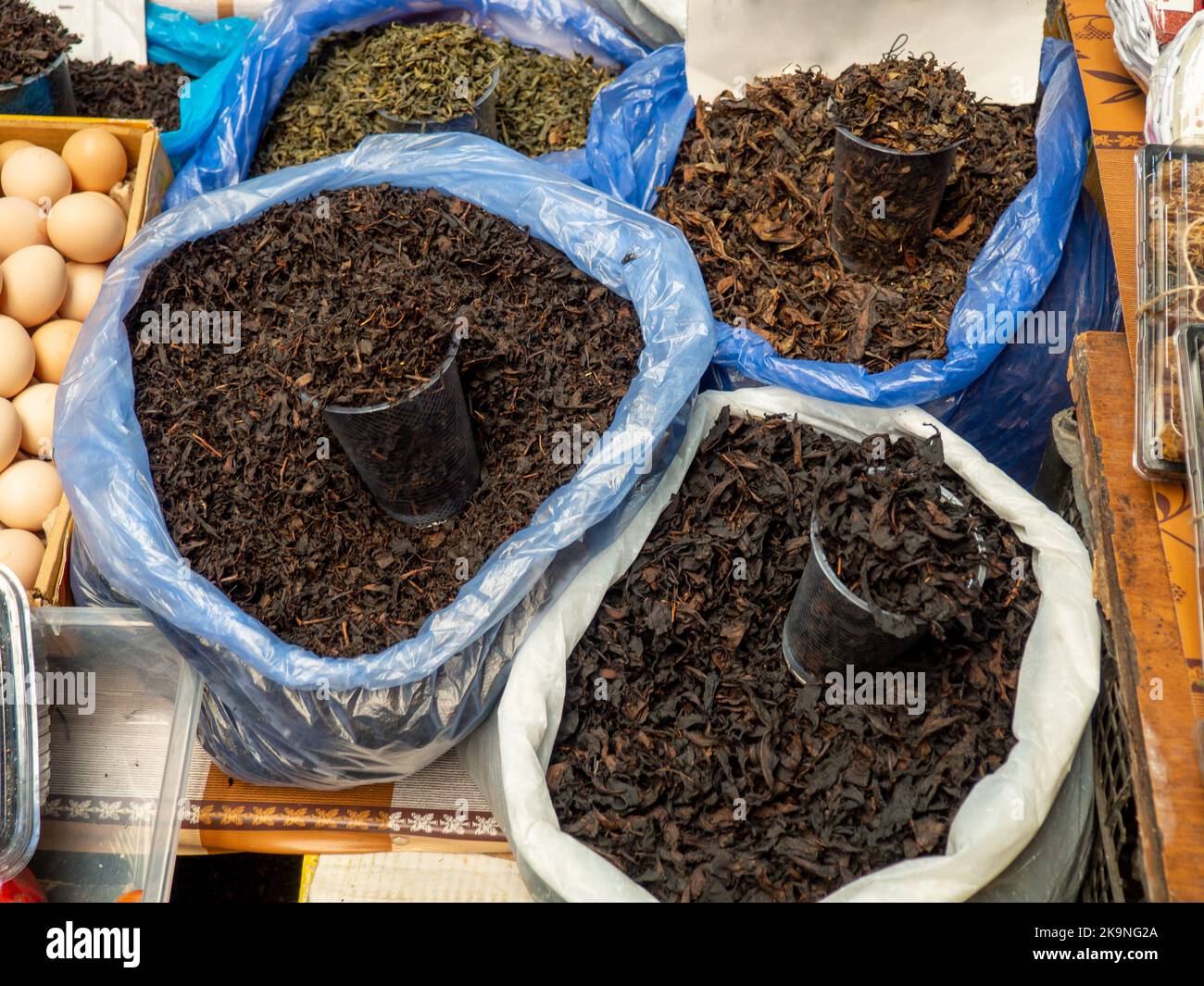 Bags with different types of tea on the market. Packing and sale of ...