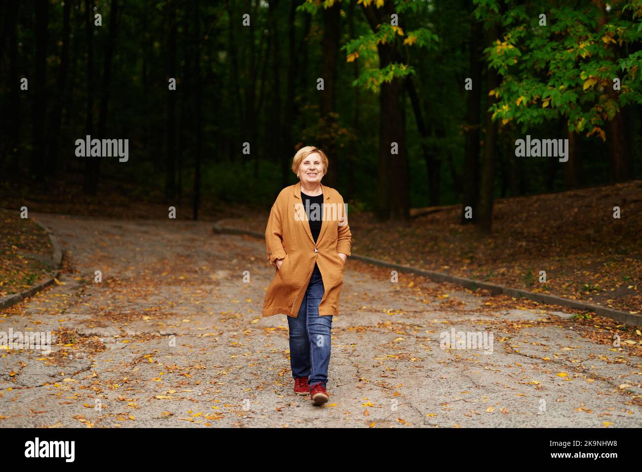 Portrait of attractive caucasian pensioner senior woman walking in the ...