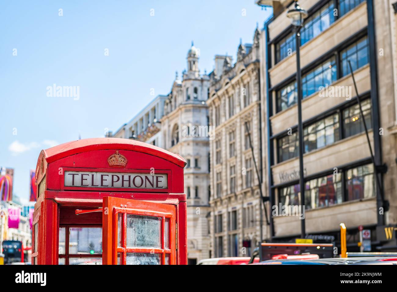 European red telephone phone box booth closeup with opened door in ...