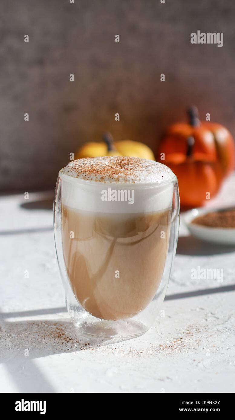 pumpkin cinnamon spice latte on white table Stock Photo - Alamy