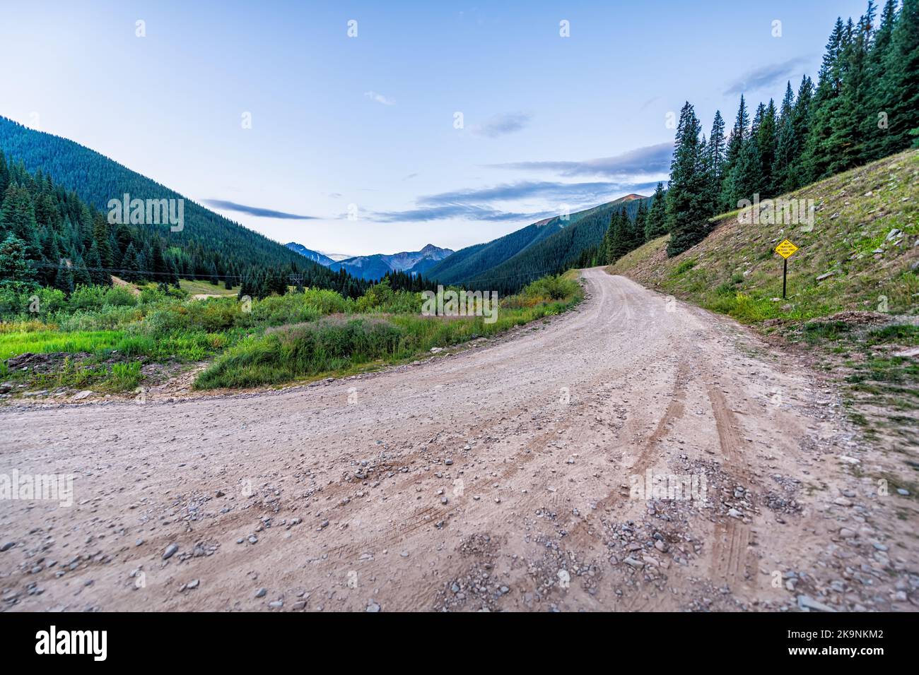 View of green alpine mountains with dirt country rural countryside road ...