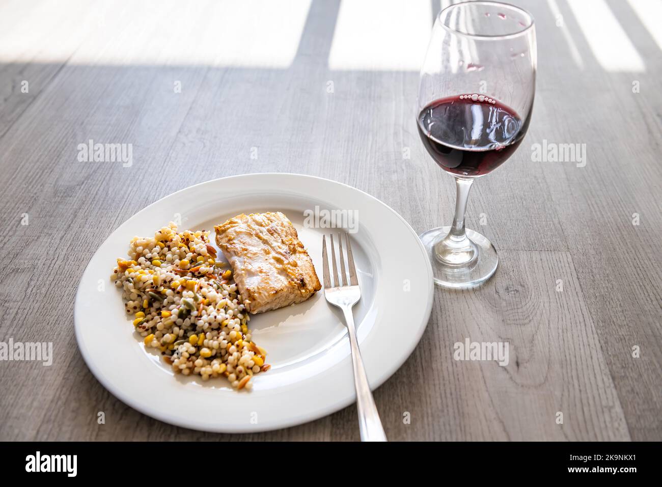 Mahi mahi fish seafood cooked fillet, fork on white plate by couscous ...