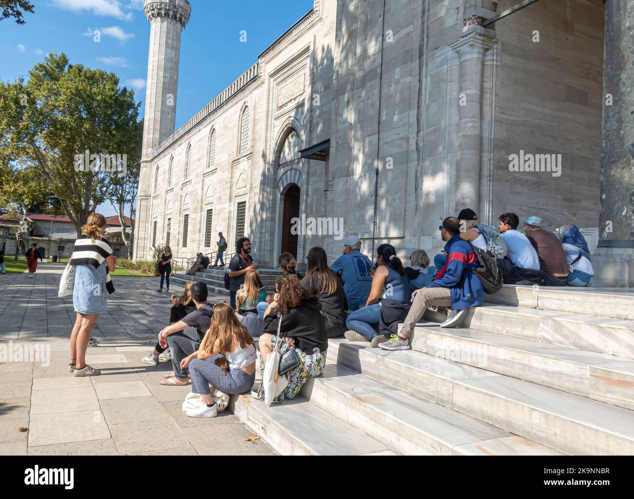 Istanbul tourism. Tour guide and group of tourists on stairs at ...