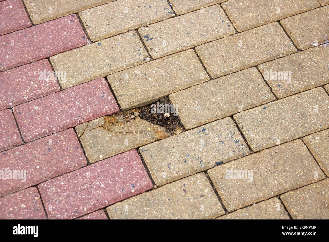 Broken brick in gray pavement close up, background Stock Photo - Alamy