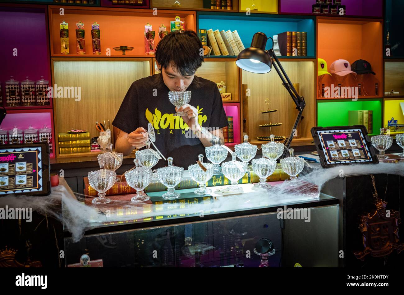 Bangkok, Thailand, 29 October, 2022. A shop assistant sniffs a jar ...