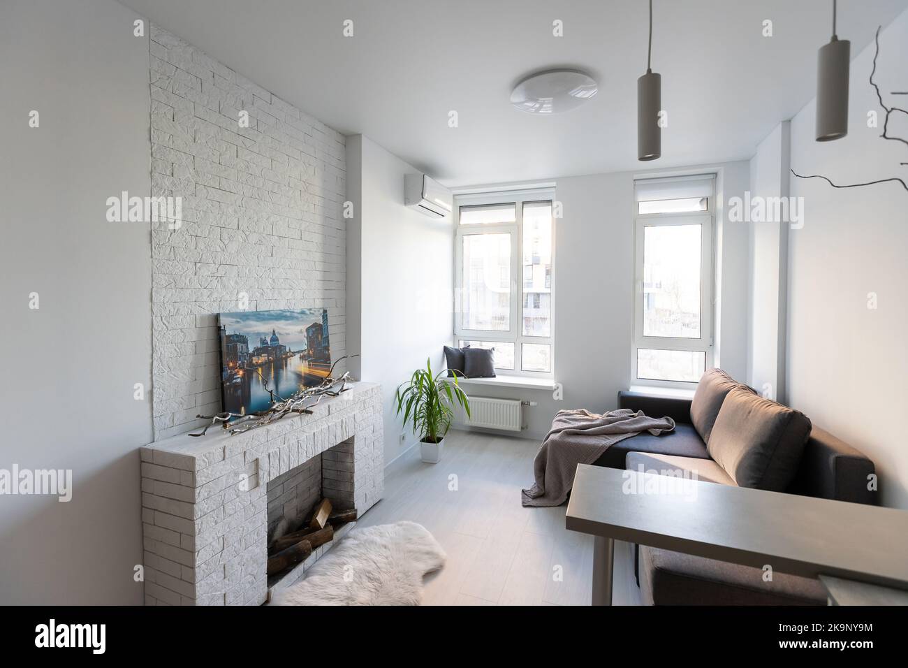 studio in minimalist style, fireplace, sofa Stock Photo - Alamy