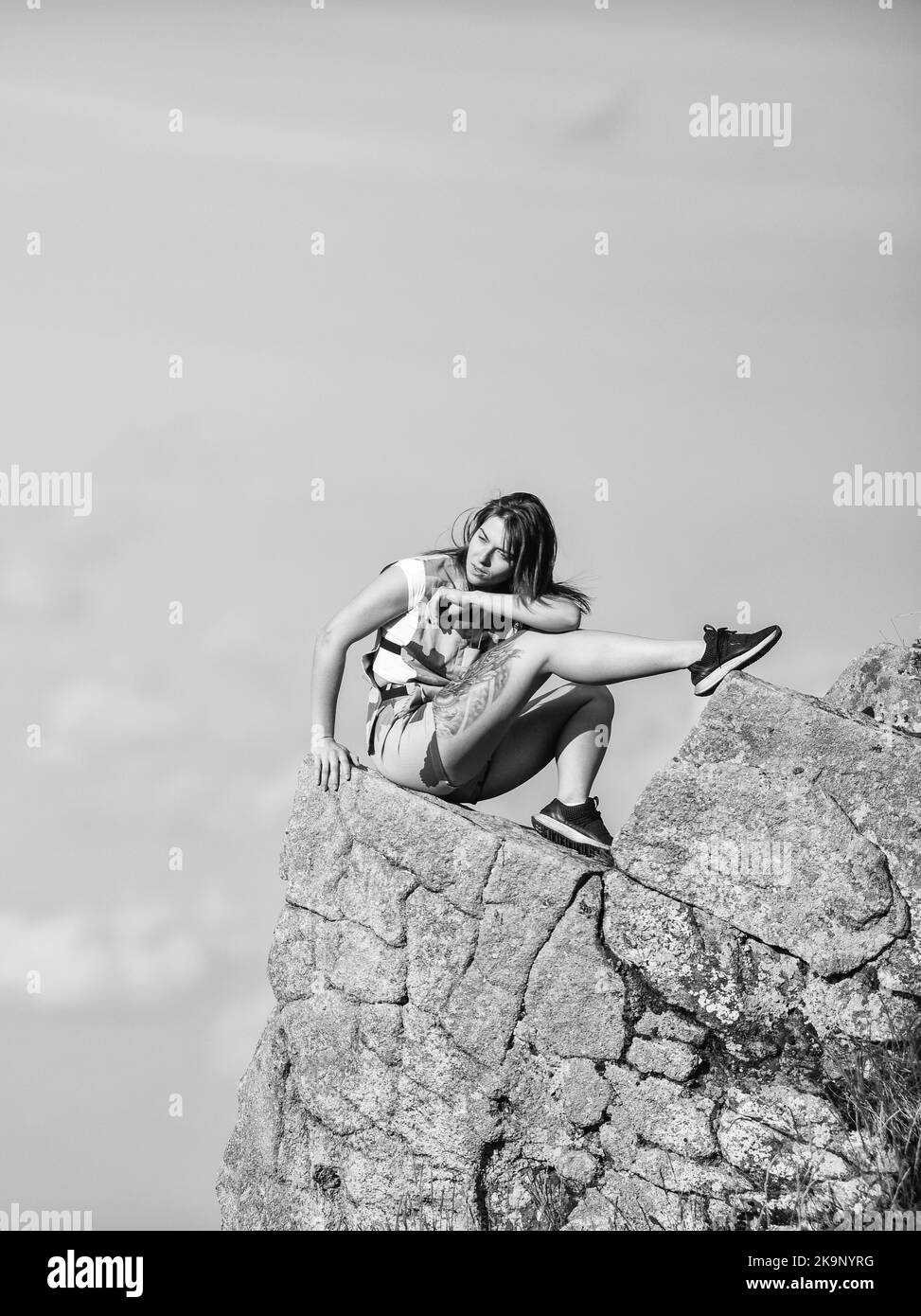 Tourist hiker girl relaxing edge cliff. Dangerous relax. Extreme ...