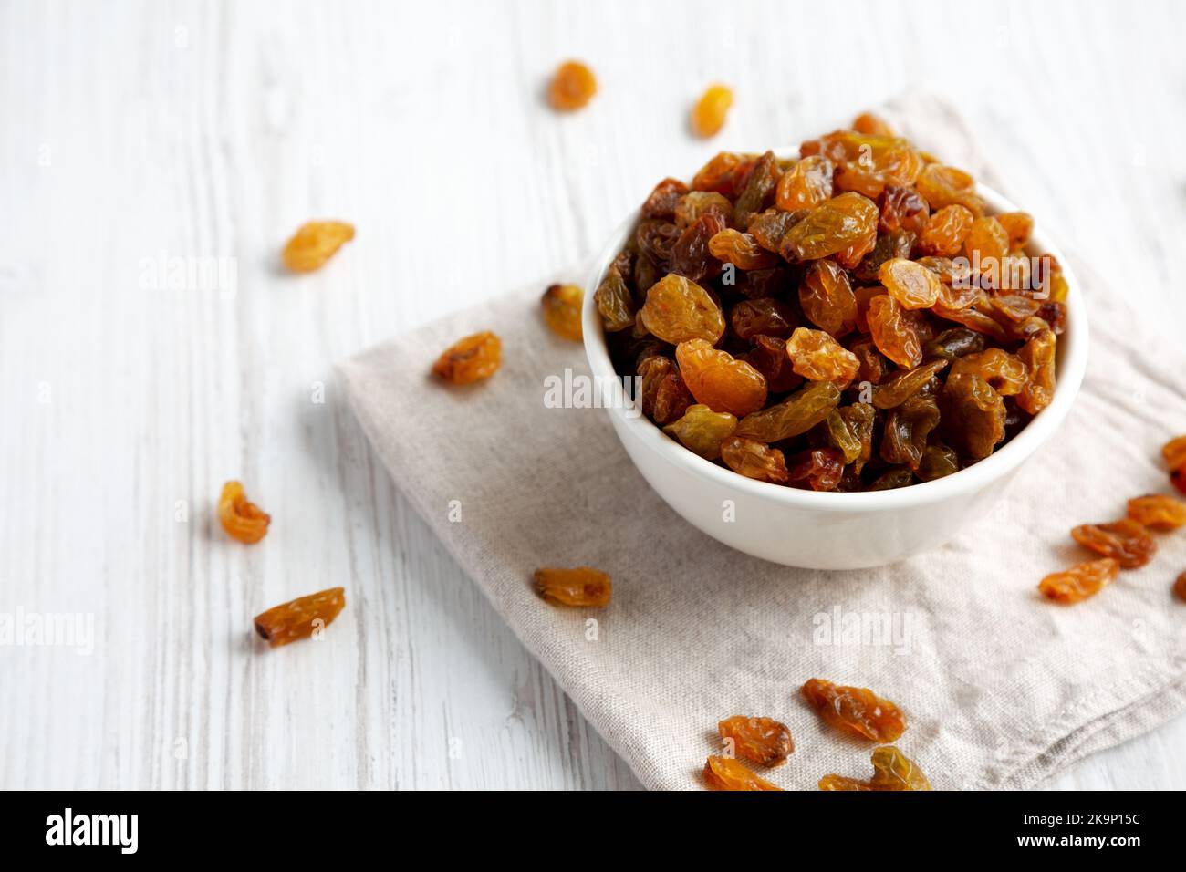 Organic Dried Raisins in a White Bowl, low angle view Stock Photo - Alamy