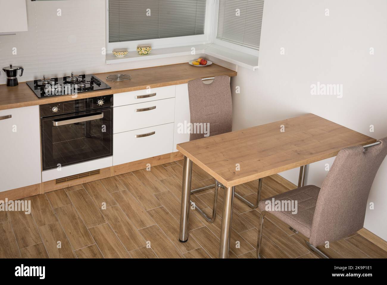 Small kitchen for two people with ceramic tiles floor Stock Photo - Alamy
