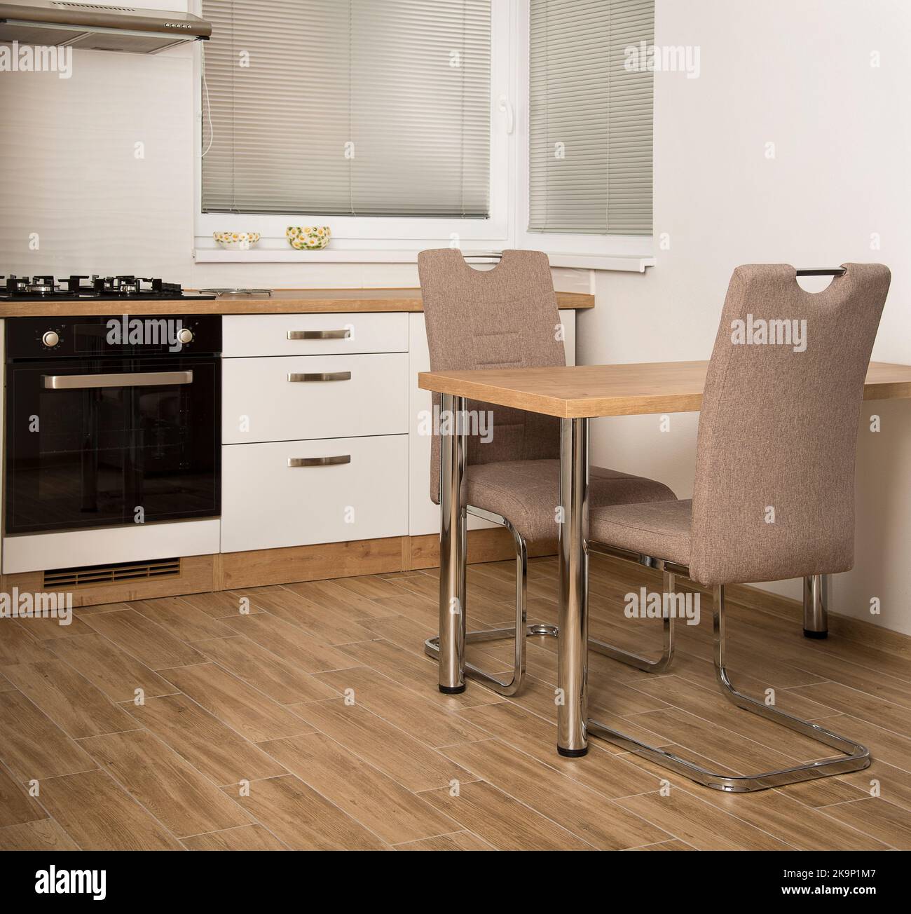 Small kitchen for two people with ceramic tiles floor Stock Photo - Alamy