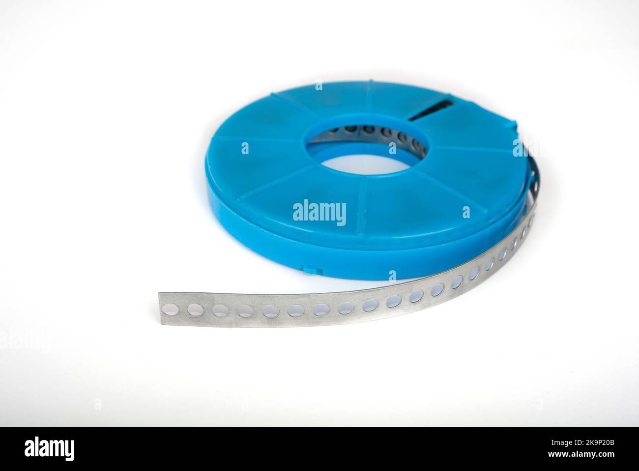 Perforated galvanized steel strip on a white Stock Photo - Alamy