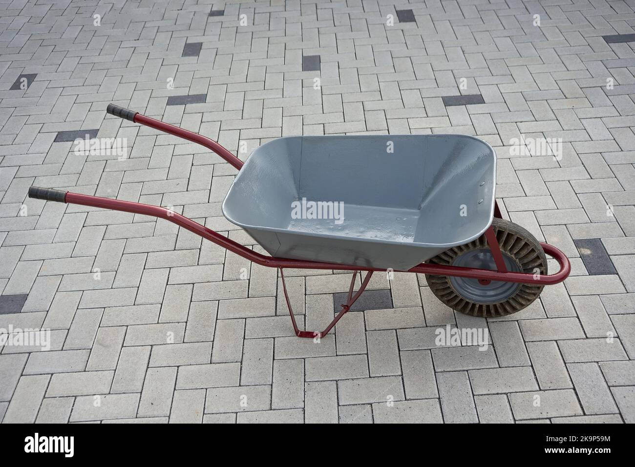 Painted wheelbarrow on a concrete tiles Stock Photo - Alamy