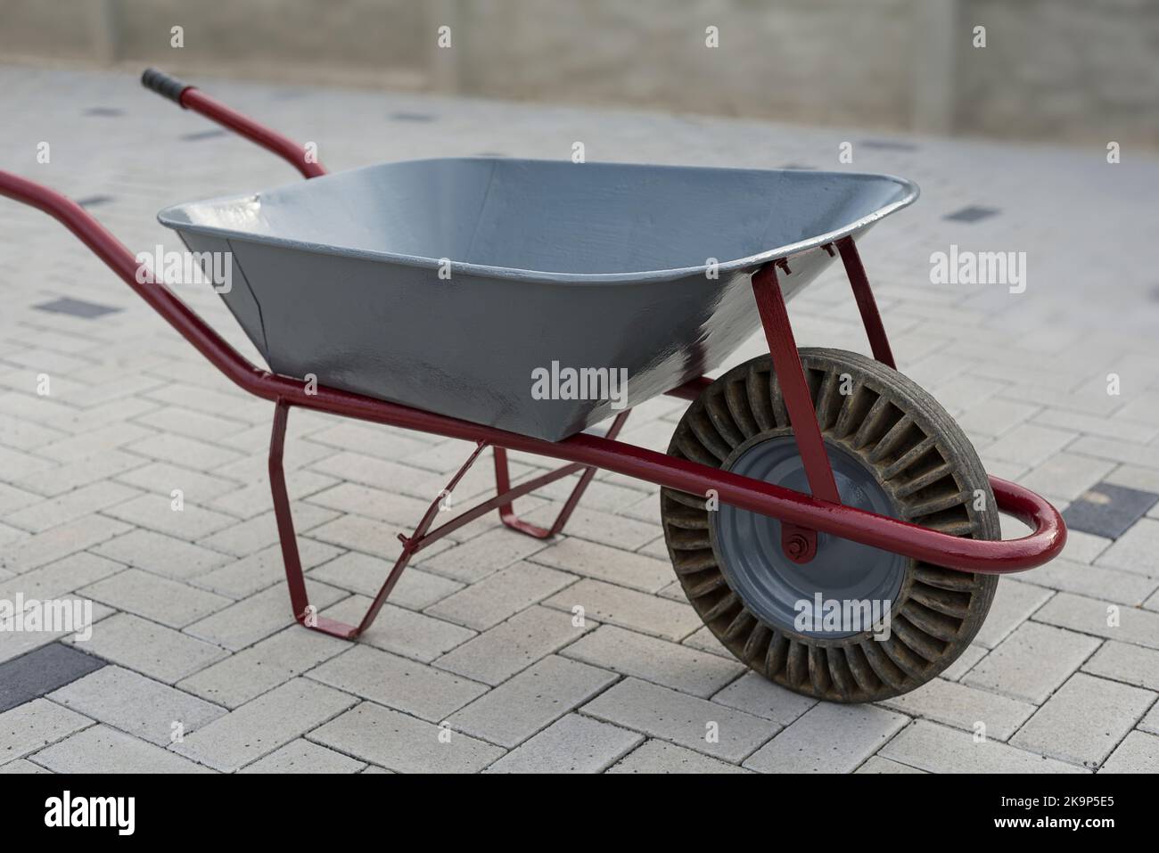 Painted wheelbarrow on a concrete tiles Stock Photo - Alamy
