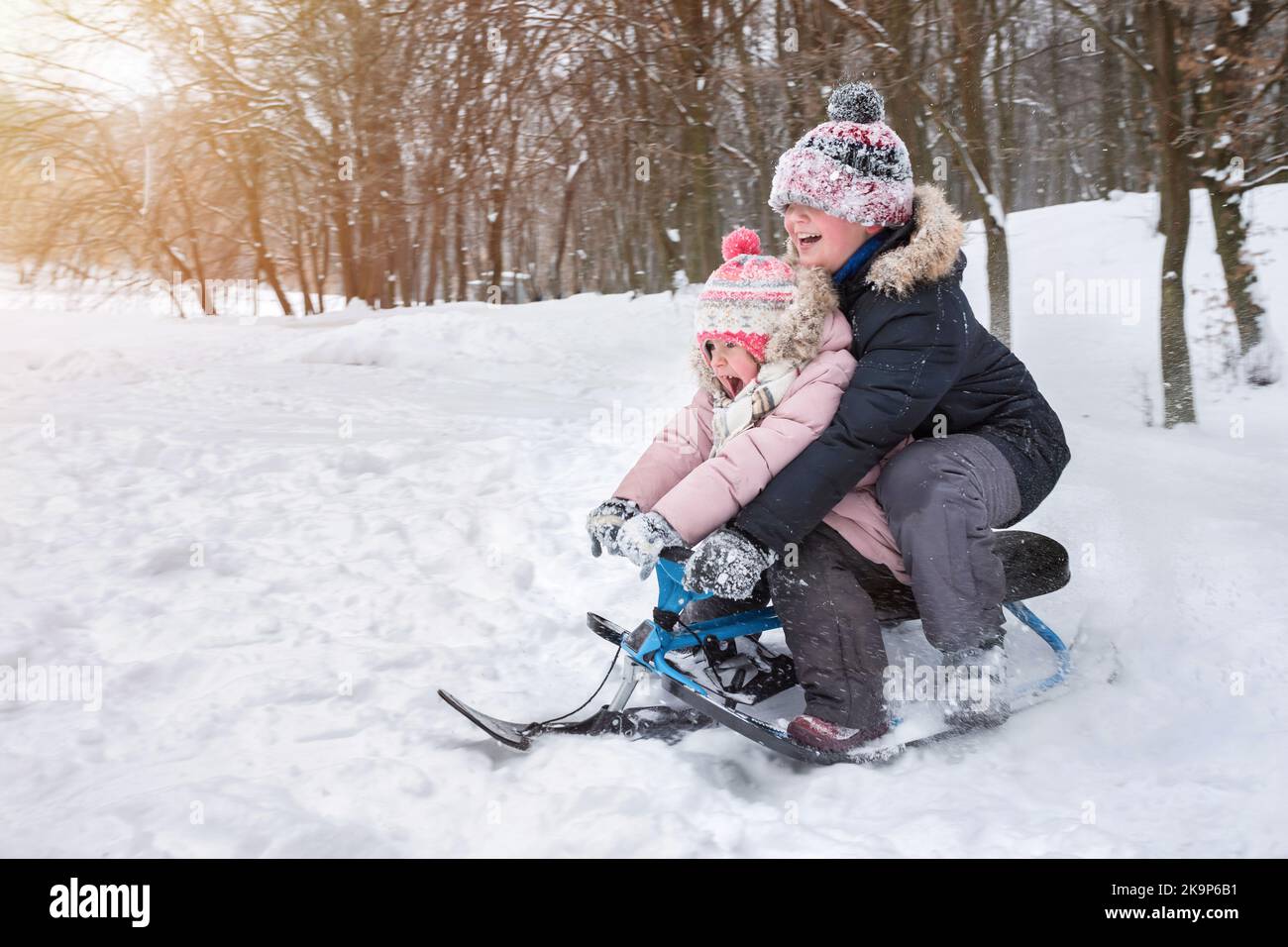 Children in winter outdoors ride a snow scooter Stock Photo - Alamy