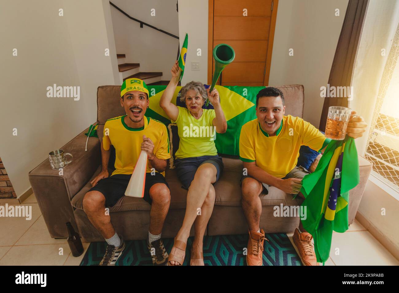 Group of Soccer Fans Celebrating the cup in the living room watching ...