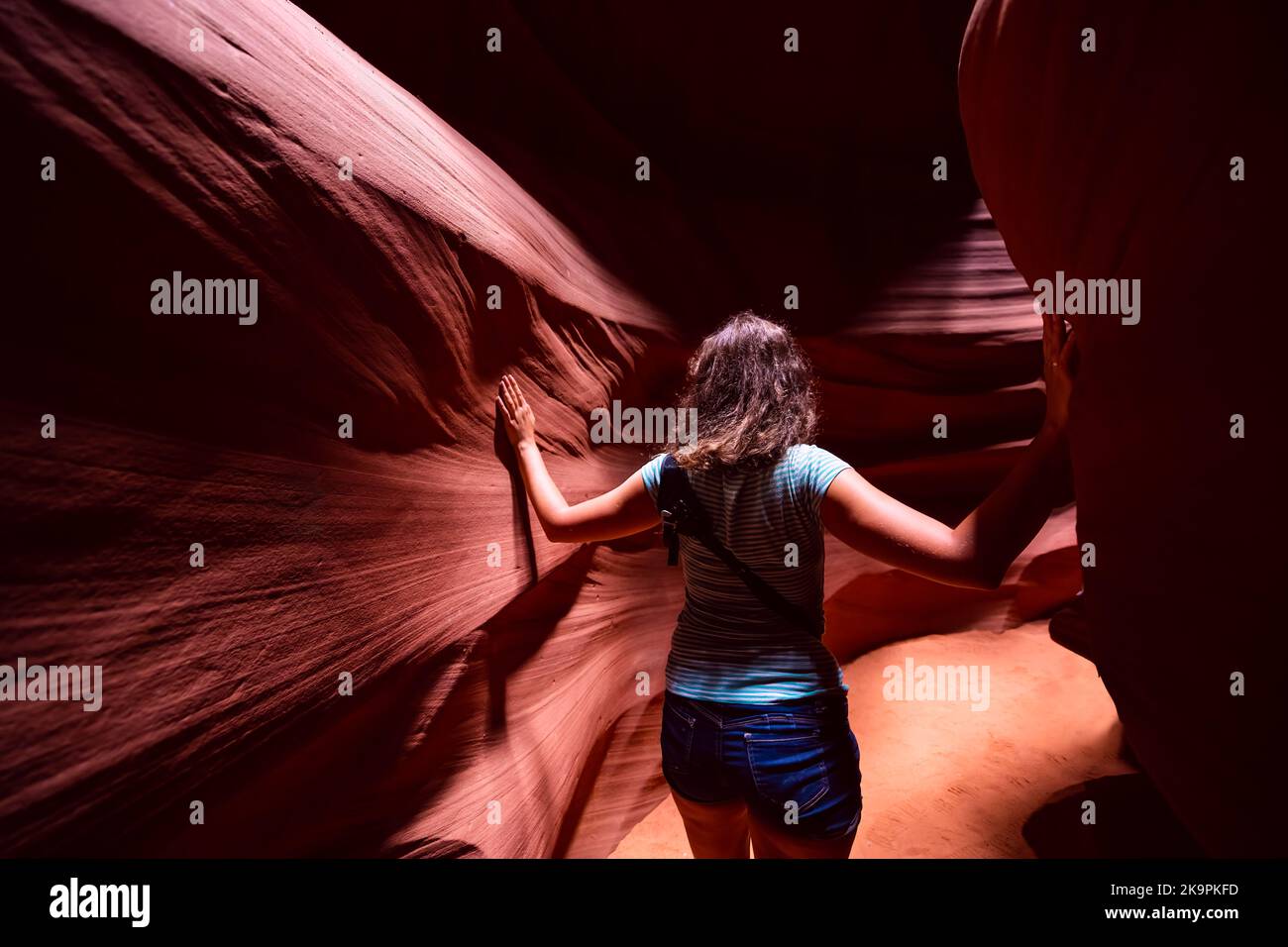 Young woman back inside Upper Antelope slot canyon, Arizona standing ...