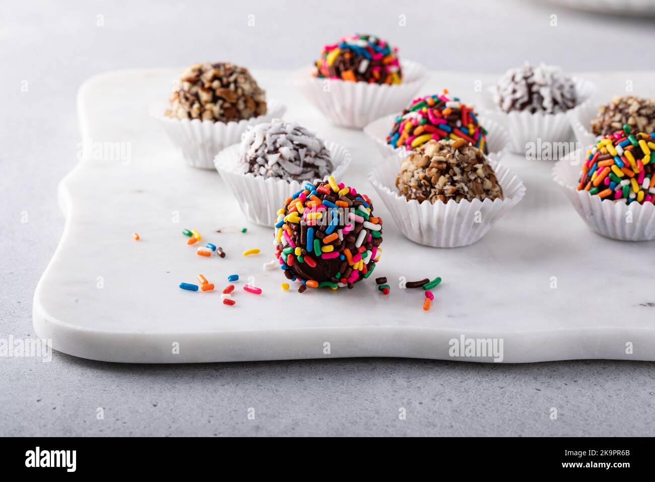 Homemade chocolate truffles covered with sprinkles and nuts Stock Photo ...