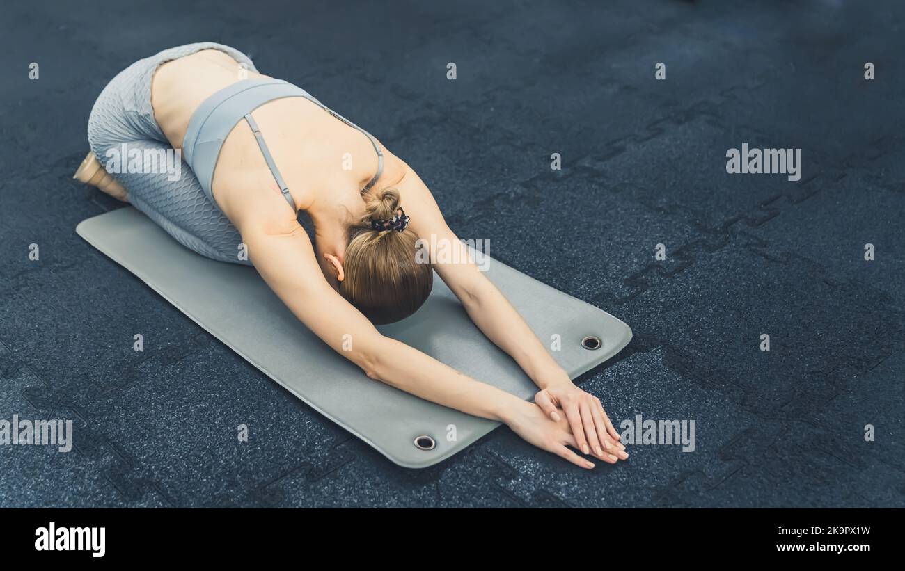 Yoga - child's pose. Skinny caucasian female yoga teacher in her 20s ...