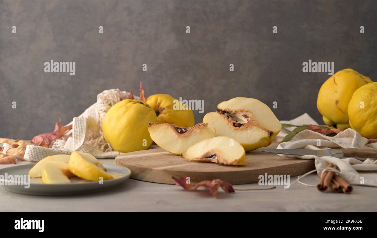 Ripe yellow quinces or queen apple fruits and sliced quince halves with ...