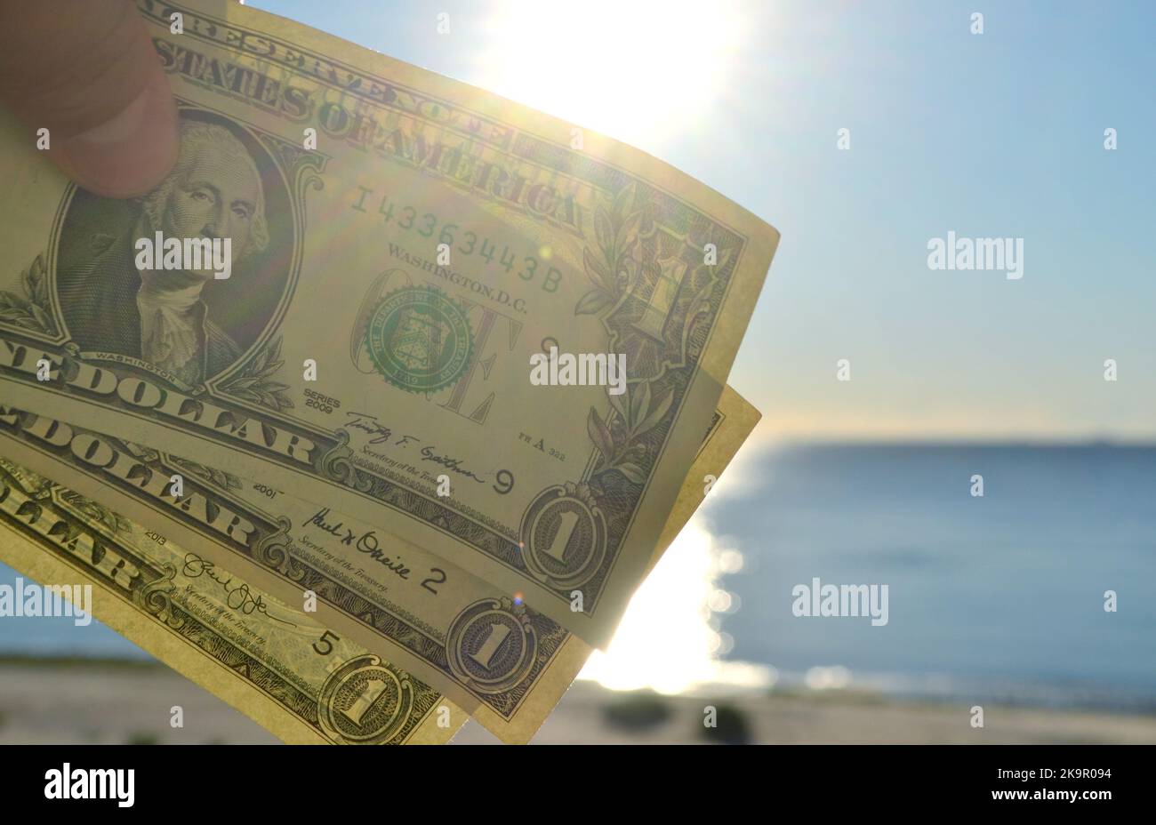 Person holding in hand paper bills of dollars with face value of one ...