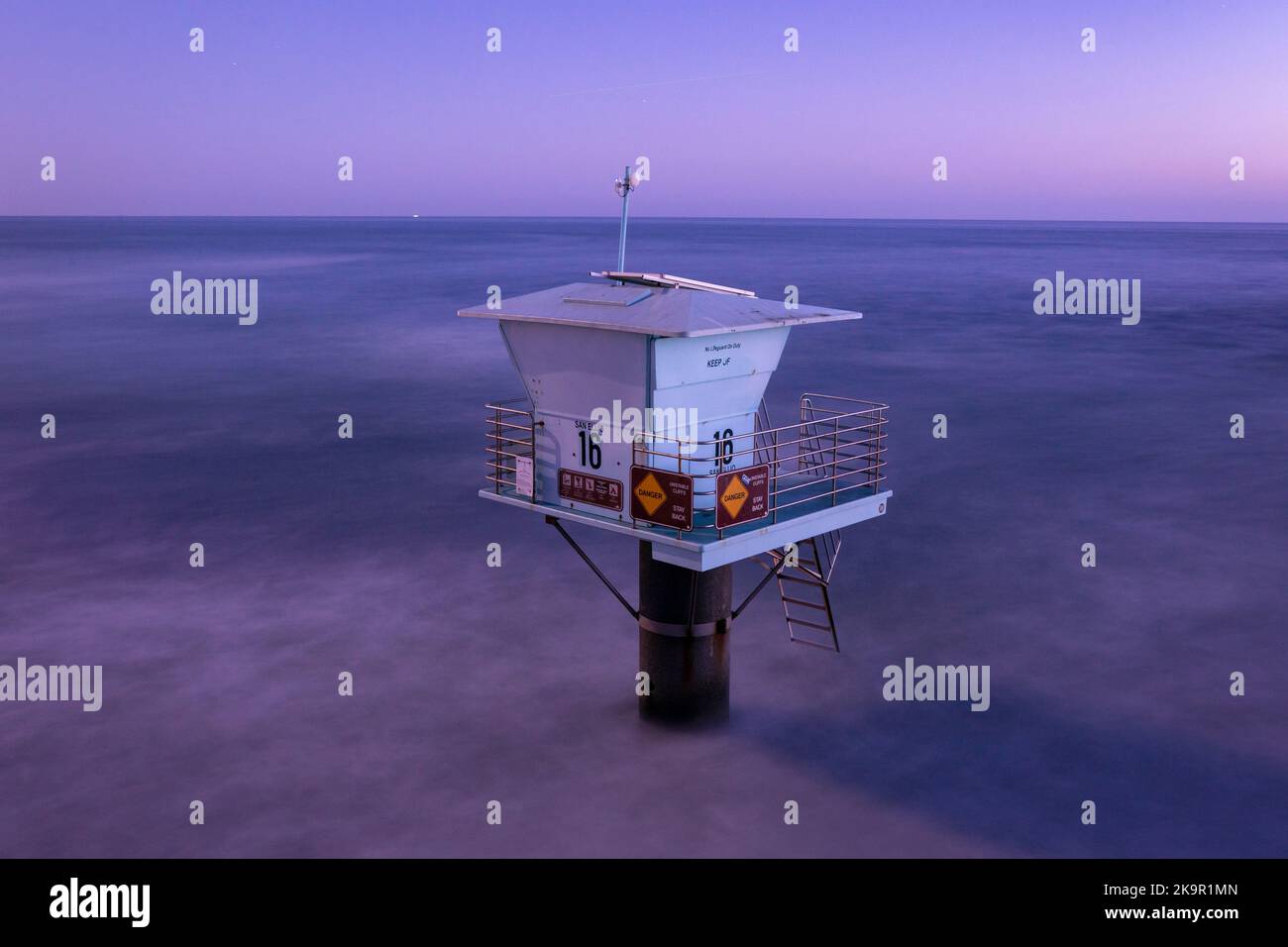 Long exposure of the Pacific Ocean surrounding a lifeguard tower at ...